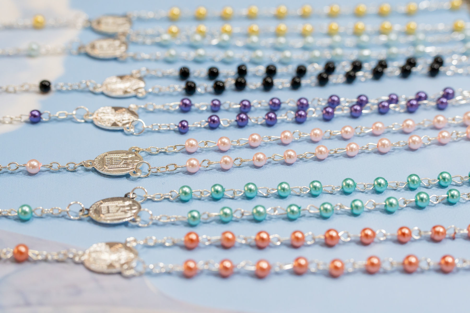 Colorful rosaries in a box | Official Parish Medjugorje Webshop